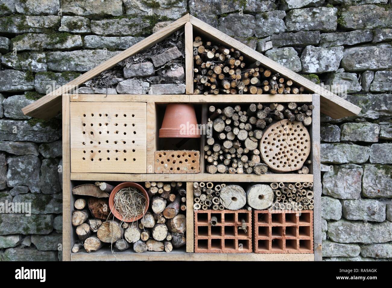 Insect hotel against a wall Stock Photo - Alamy