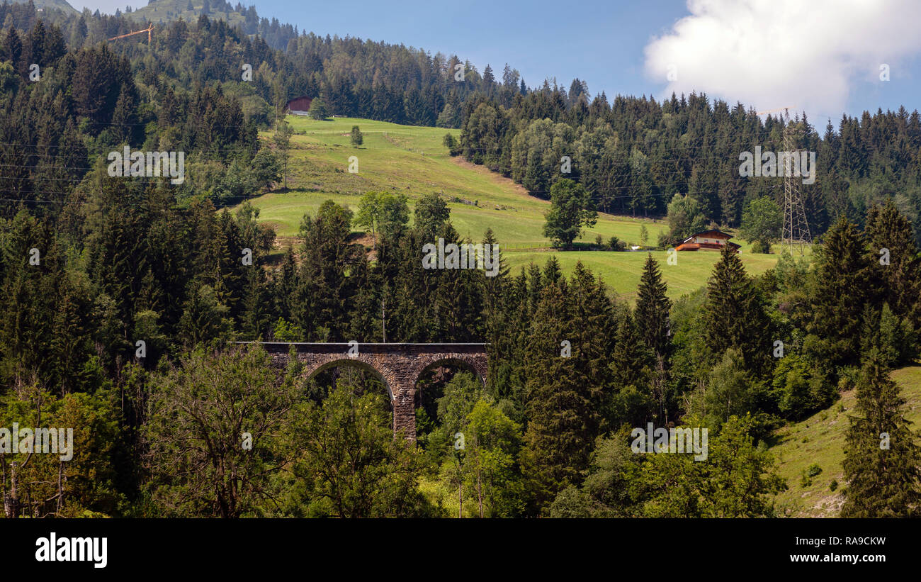 A picturesque Alpine landscape with an old railway bridge. Austria ...