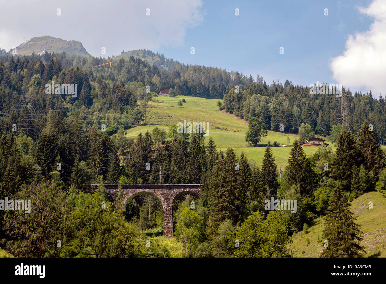 A picturesque Alpine landscape with an old railway bridge. Austria ...