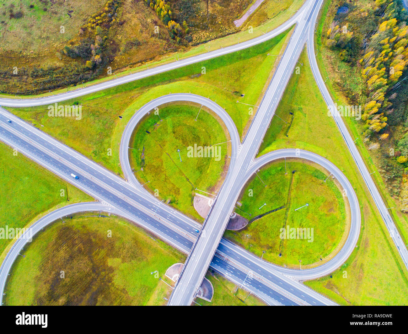 Aerial view of highway in city. Cars crossing interchange overpass. Highway interchange with ...