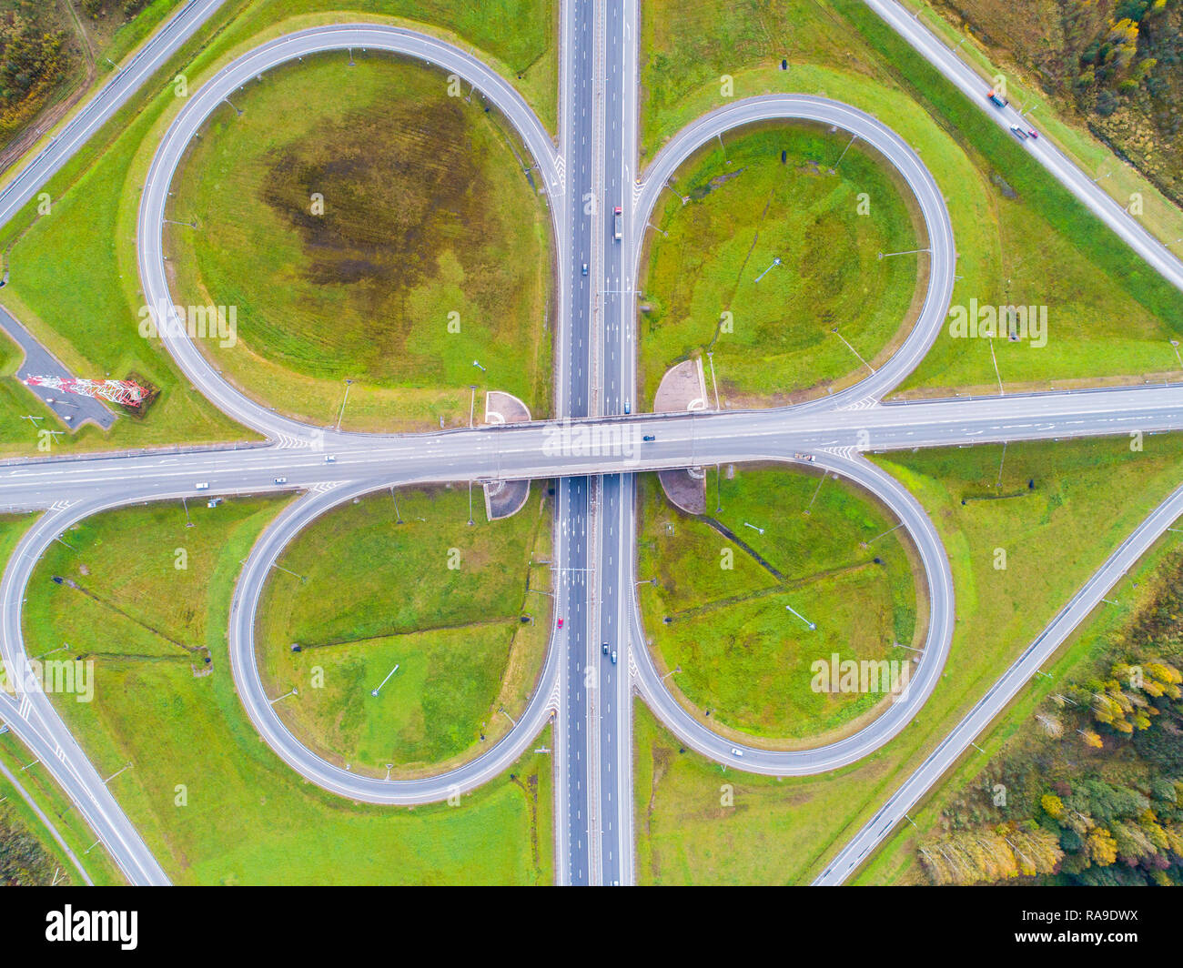Aerial view of highway in city. Cars crossing interchange overpass. Highway interchange with ...