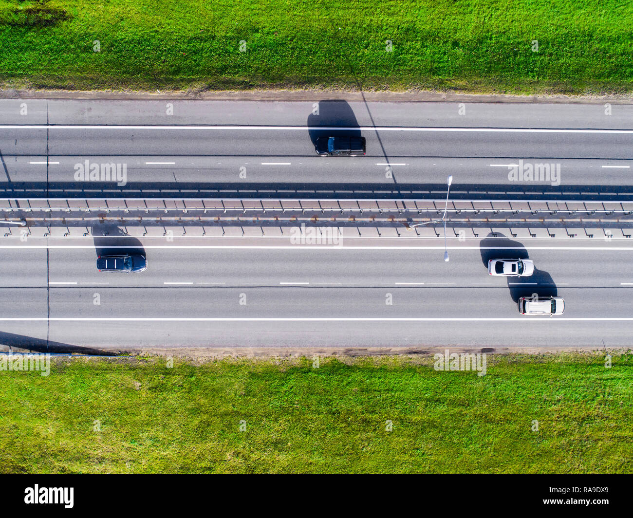 Aerial view of highway in city. Cars crossing interchange overpass. Highway interchange with ...