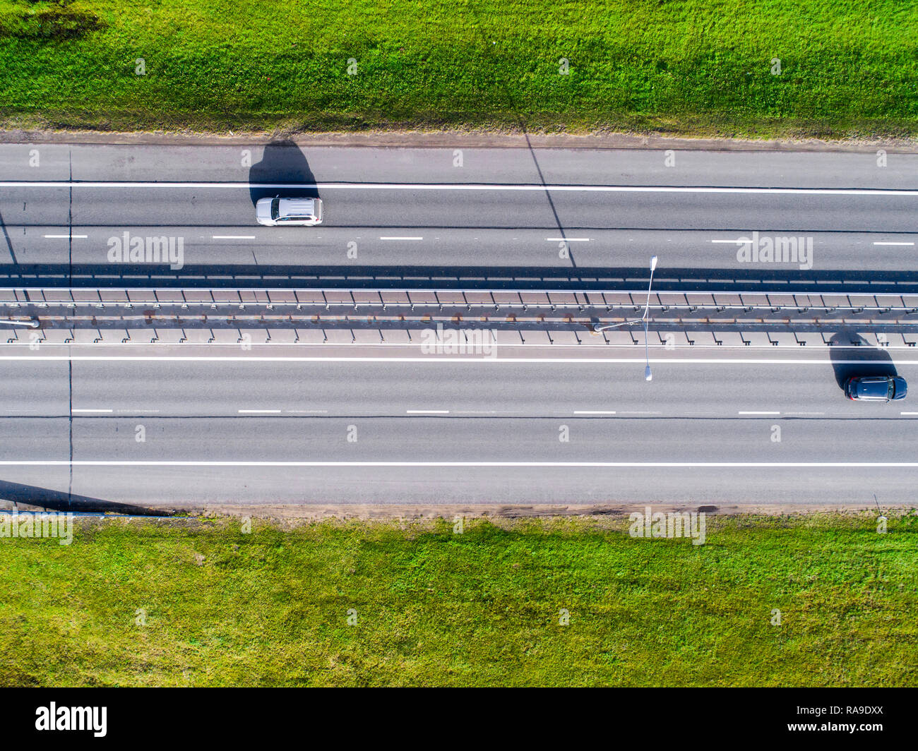 Aerial view of highway in city. Cars crossing interchange overpass ...