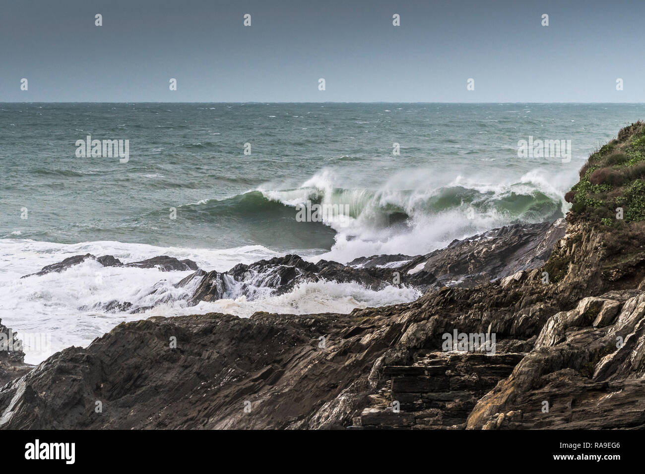 A large wave breaking on rocks Stock Photo - Alamy