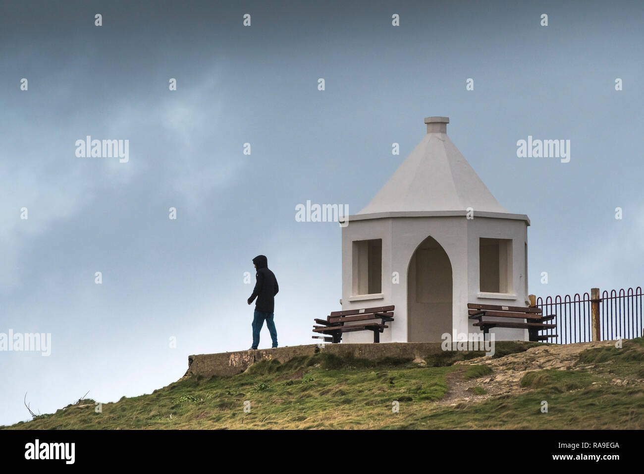 A man standing next to the historic Coastguard Lookout Station on Towan ...