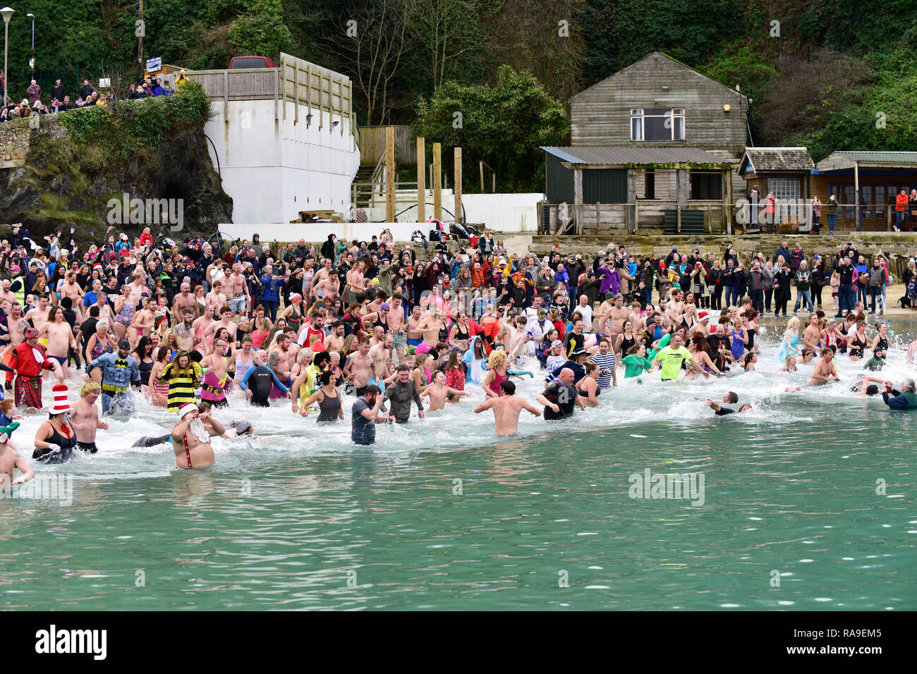 Swimmers and spectators at the New Years Day Dip in Newquay Harbour ...