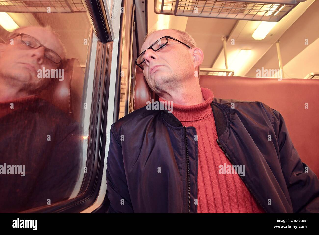 Middle age man looking out of the window of train. Passenger during ...
