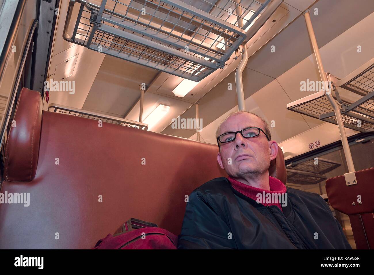 Middle age man looking out of the window of train. Passenger during ...