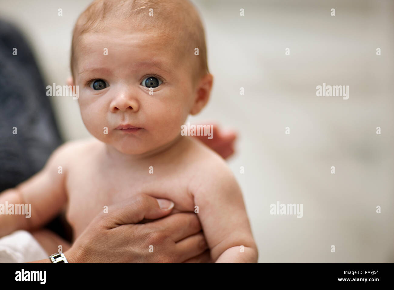 Baby looking curiously Stock Photo - Alamy