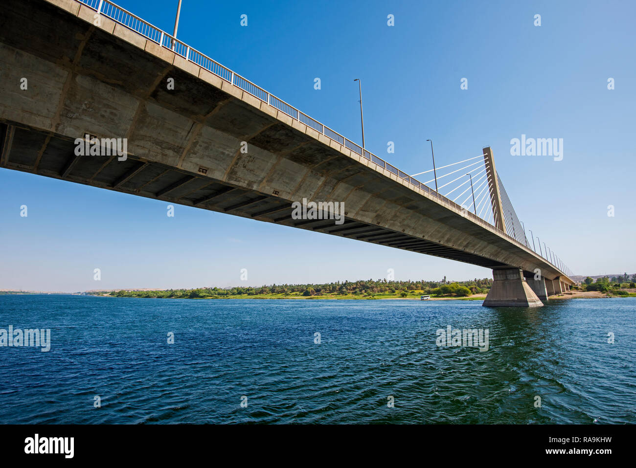 Large cable stayed road bridge spanning a wide Nile river on a clear ...