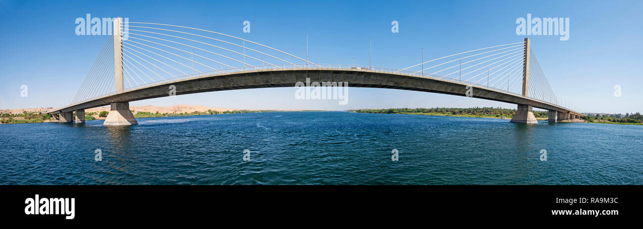 Large cable stayed road bridge spanning a wide Nile river on a clear ...