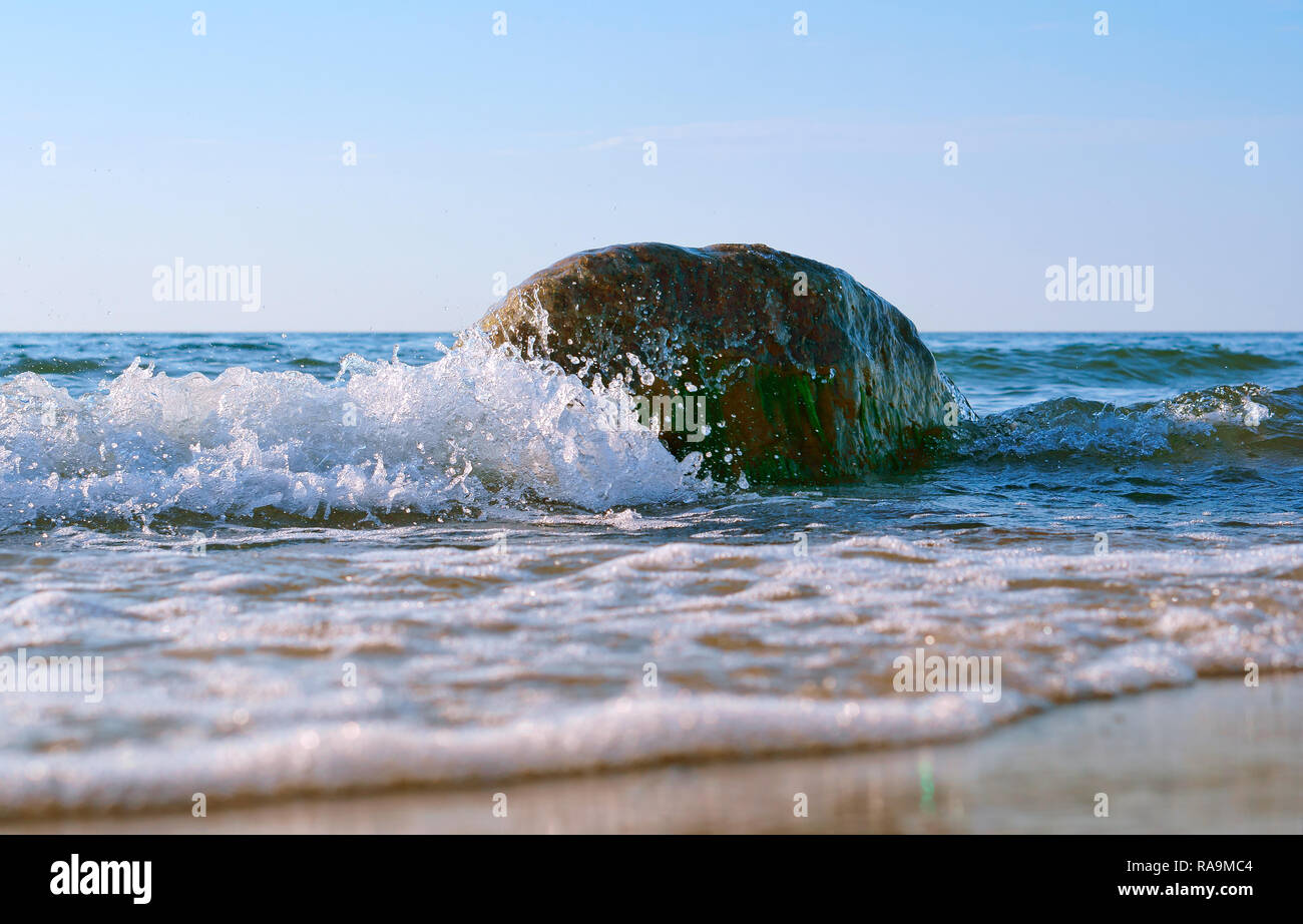 rock in the sea, the waves beating against the rocks Stock Photo - Alamy