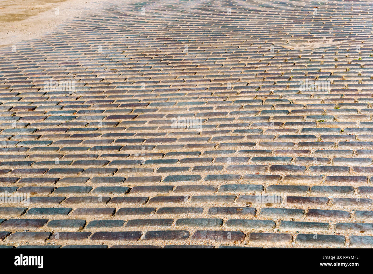 a smooth paving stone, road paving stones, cobblestones Stock Photo - Alamy