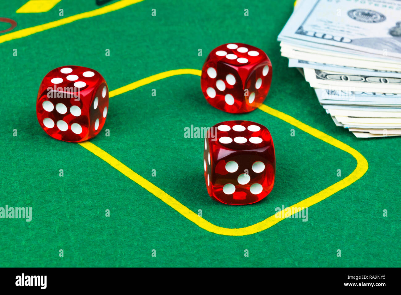 Dice rolls on a dollar bills Money. Green Poker table at the casino ...