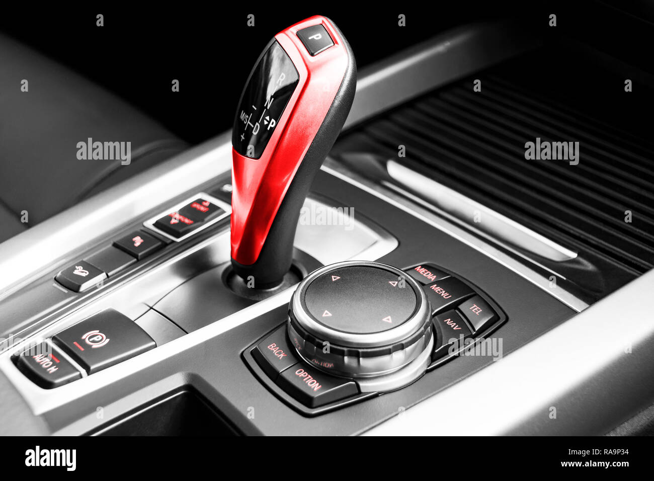 Red Automatic gear stick of a modern car, car interior details. Black ...
