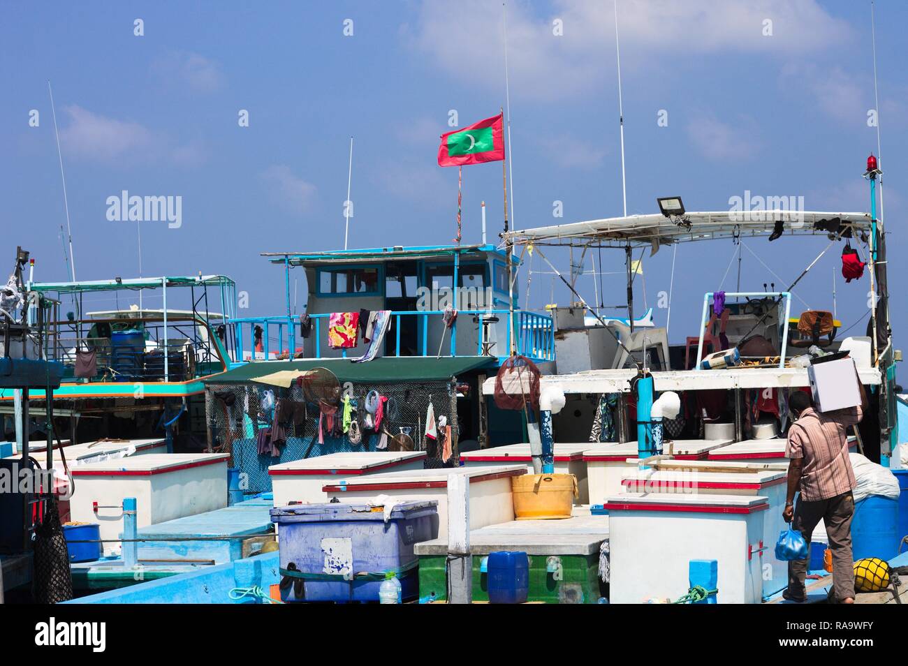 Maldivian flag over the harbor in Male fish market (Maldives, Asia ...