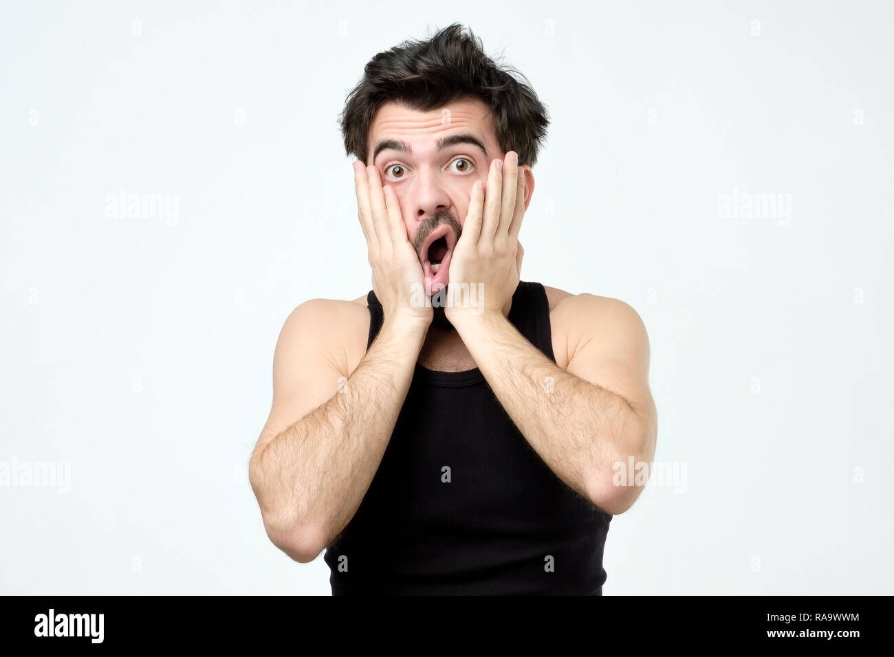 Annoyed tired handsome guy with bristle, leaning face on hand and ...