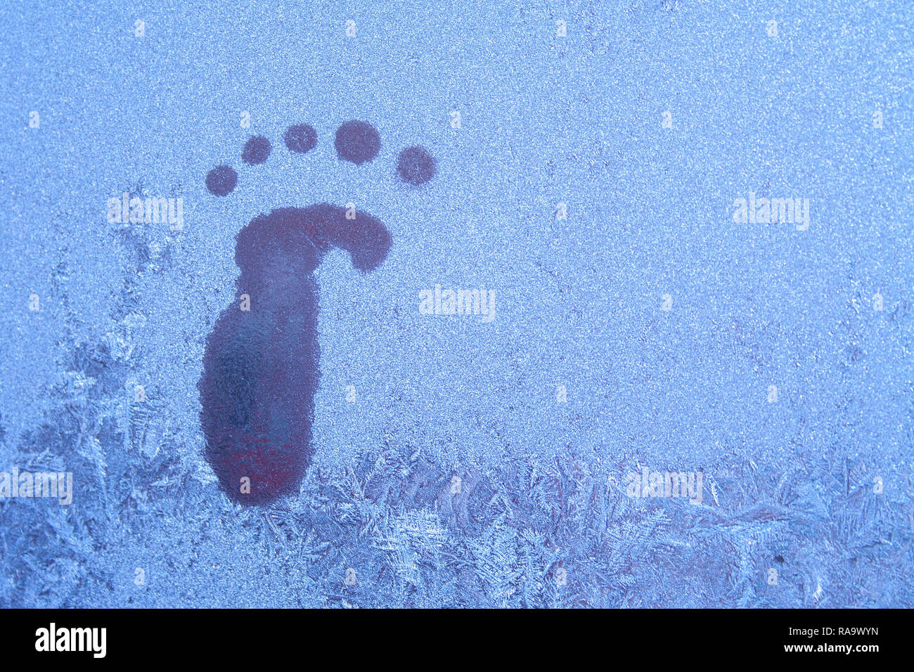 Foot print on icy window. Close up of foot print Stock Photo - Alamy