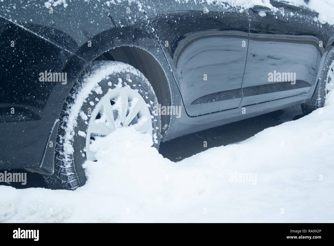 Wheel of black car at snow close up. Winter driving concept Stock Photo ...