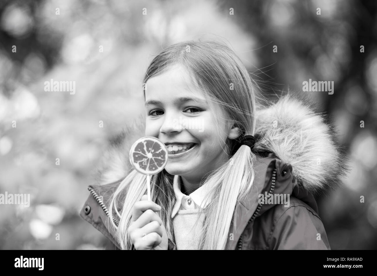 Little girl eat candy on stick, food. Child smile with lollipop, snack ...