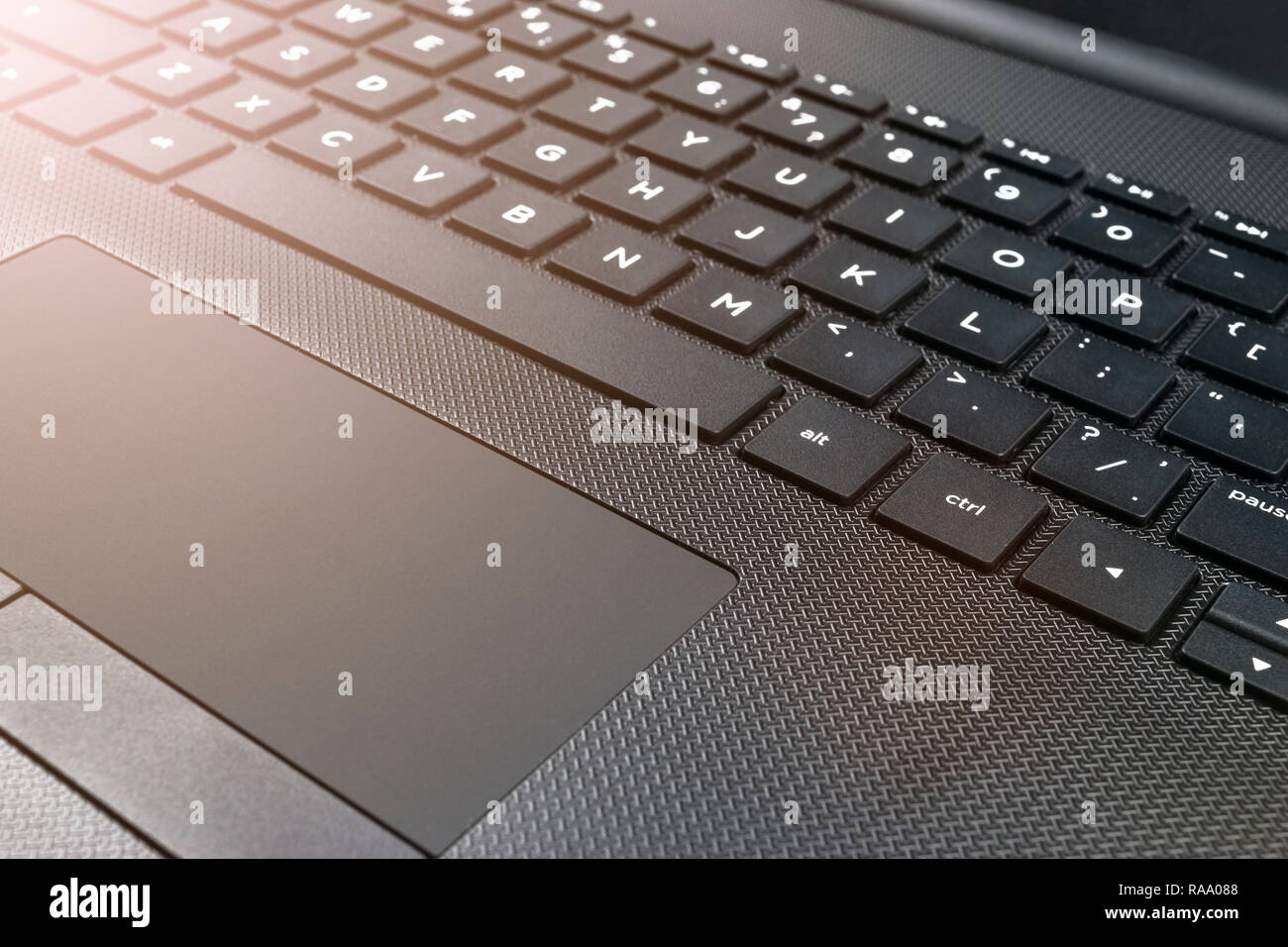 Close up view of a modern laptop computer keyboard keys and track pad ...