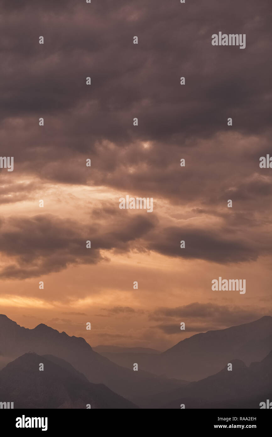 Beautiful golden sunset over peaks of mountains. Charming nature ...