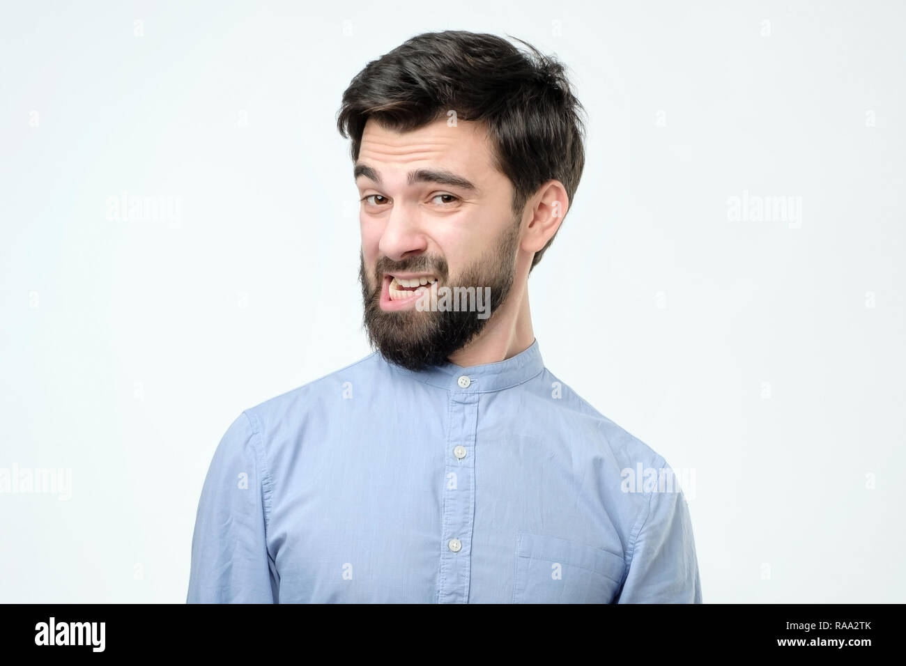 It is so gross. Young man with disgusted expression repulsing something ...