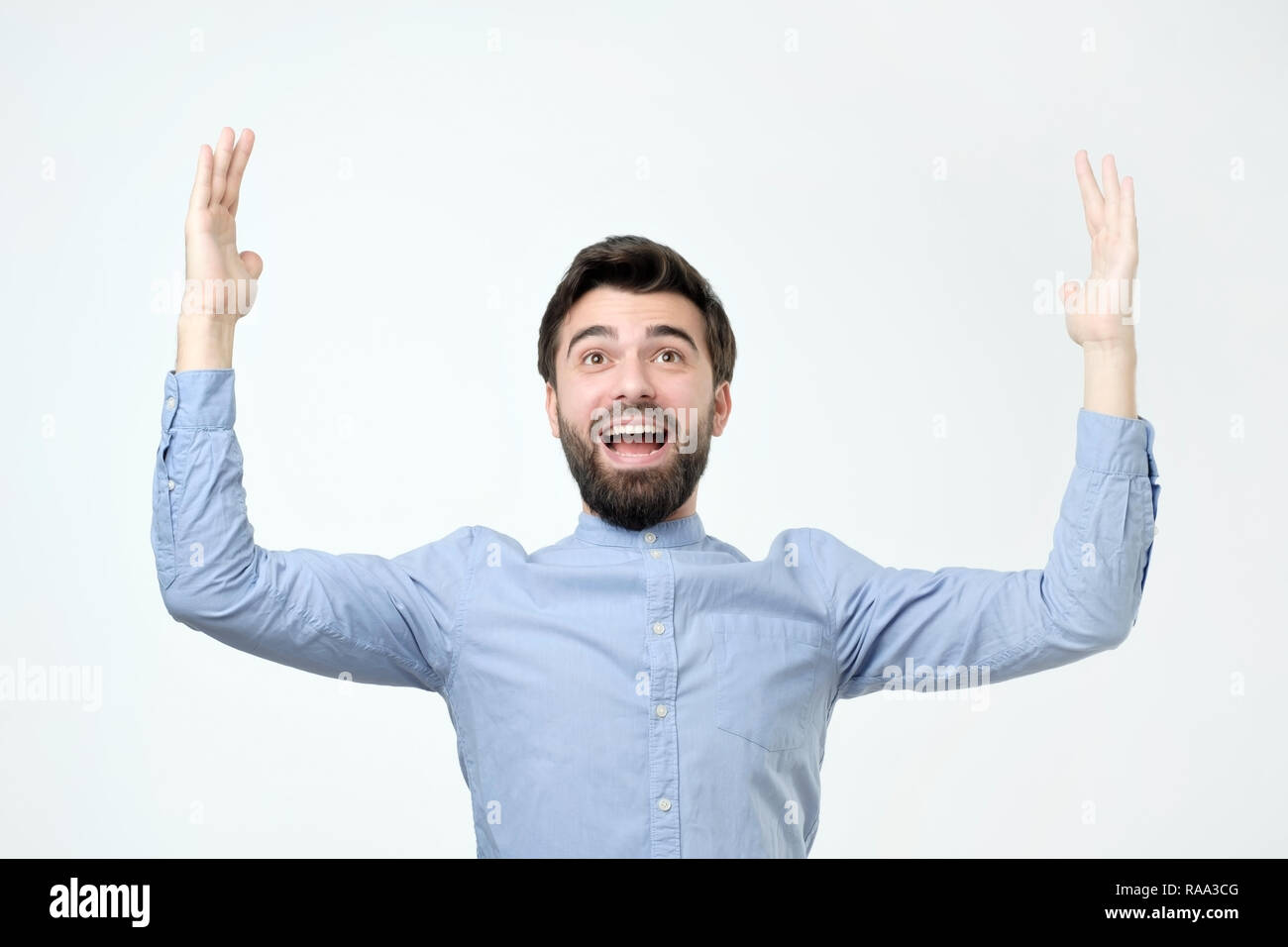 Happy young bearded man bragging about the big size of something Stock ...