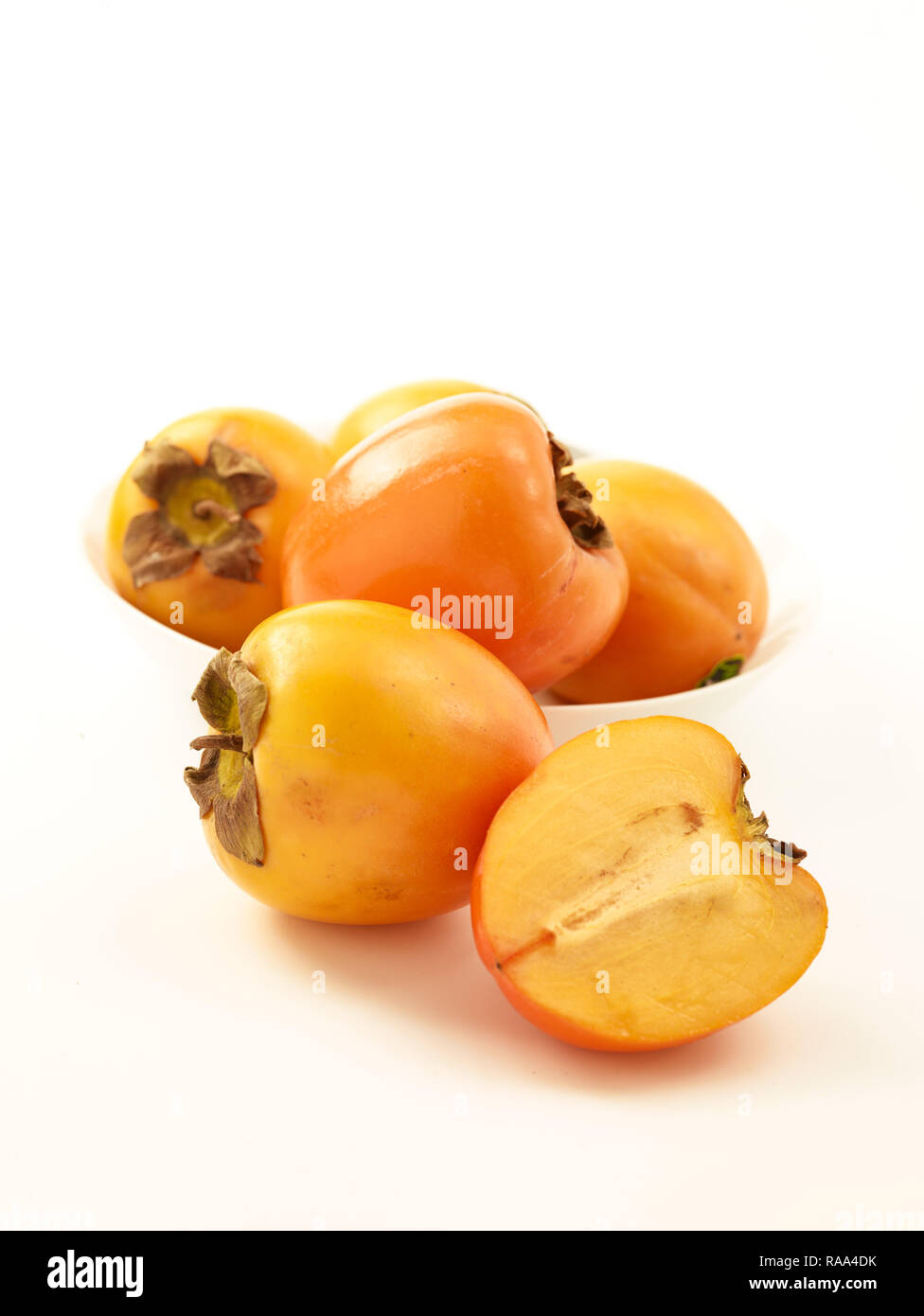 Sharon fruit against white background, food portrait Stock Photo - Alamy