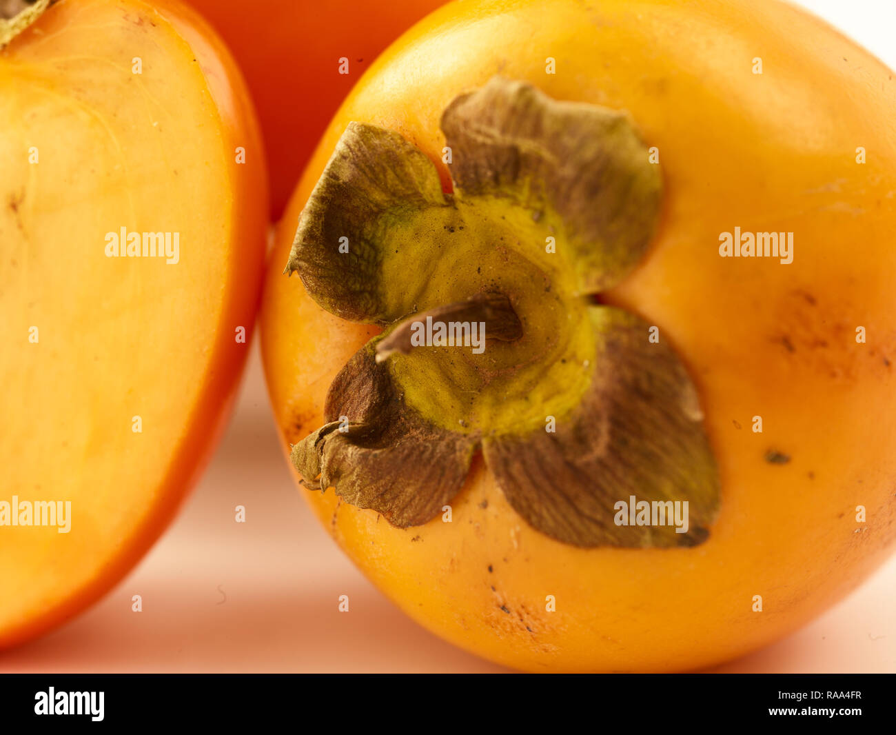 Sharon fruit against white background, food portrait Stock Photo - Alamy