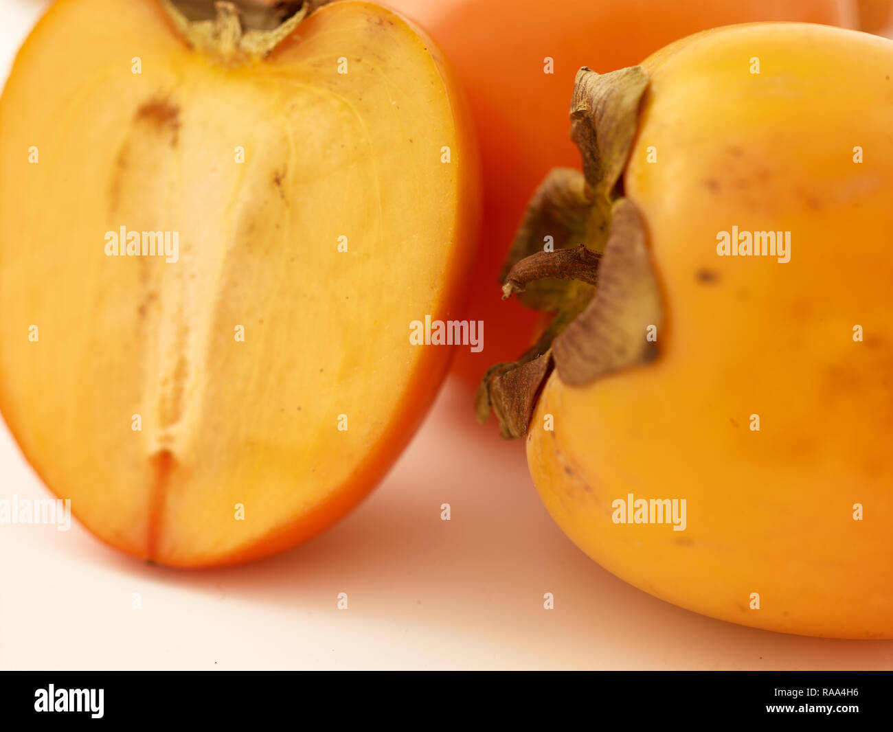 Sharon fruit against white background, food portrait Stock Photo - Alamy