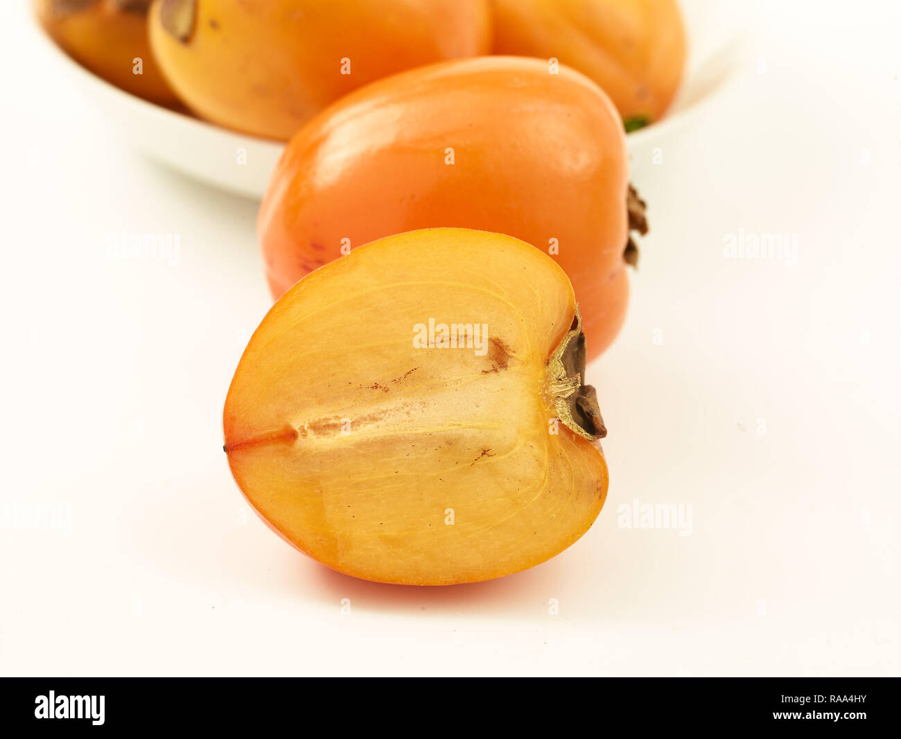 Sharon fruit against a white background fruit still-life Stock Photo ...