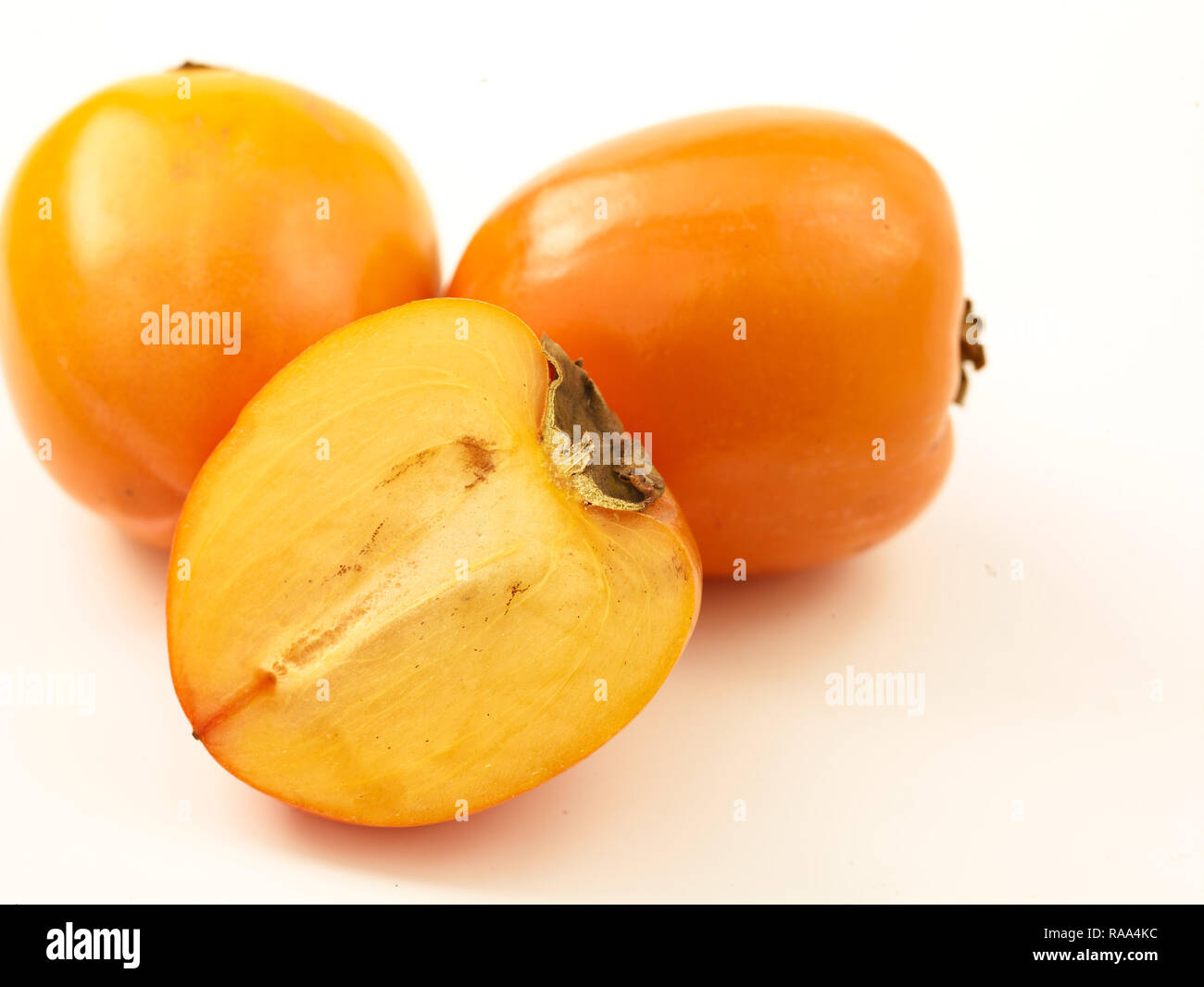 Sharon fruit against a white background fruit still-life Stock Photo ...