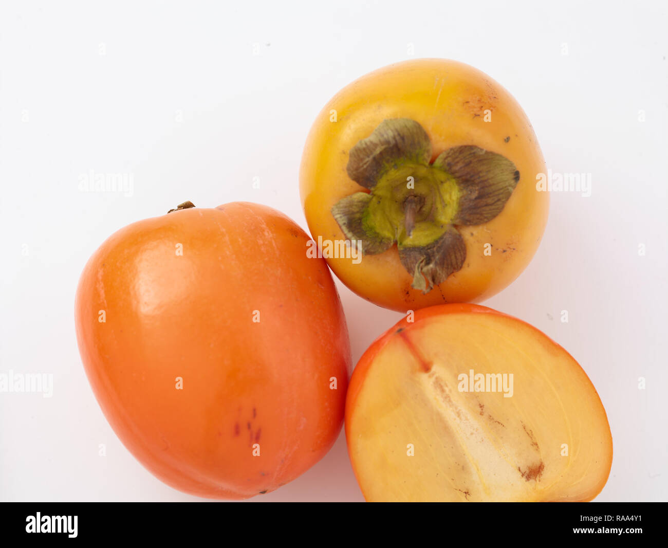 Sharon fruit against white background, food portrait Stock Photo - Alamy