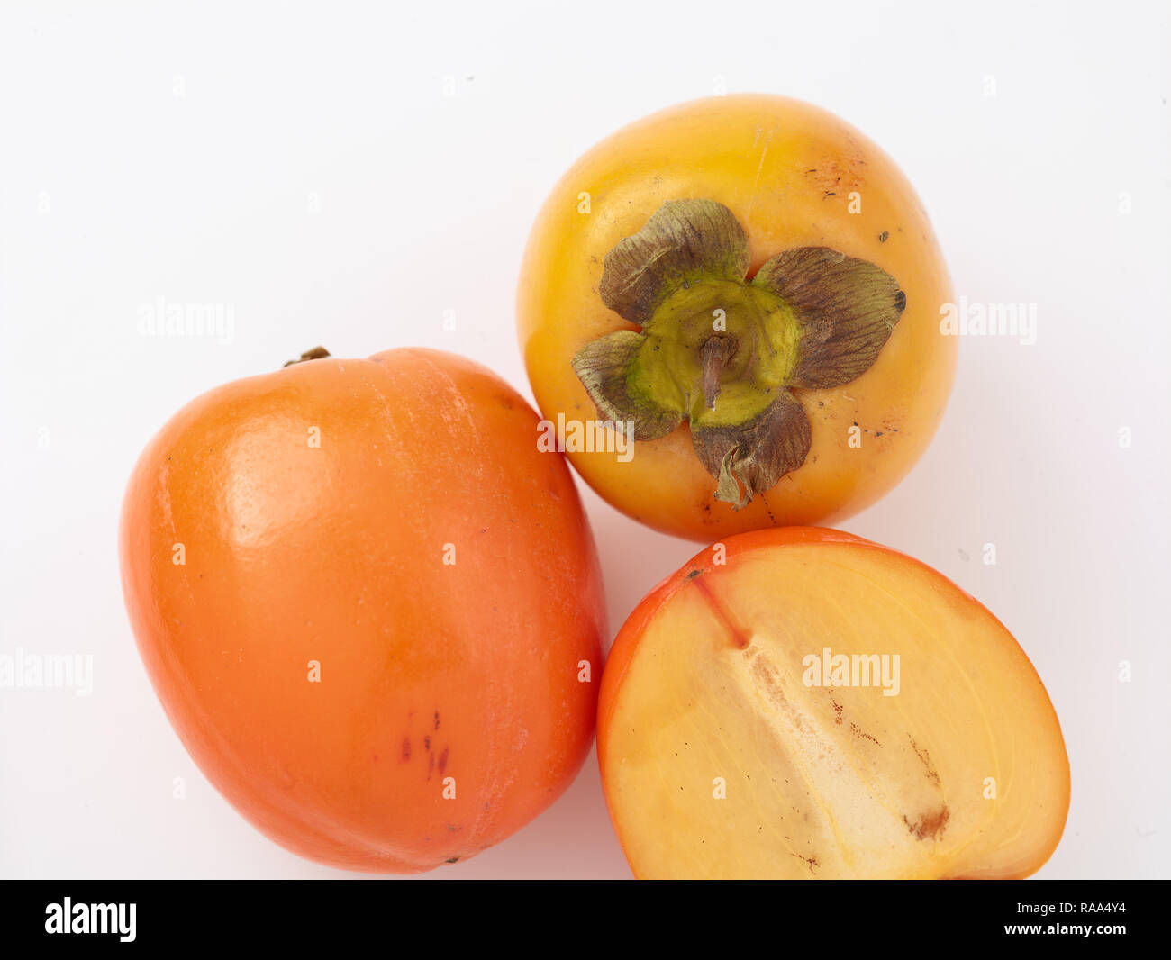 Sharon fruit against white background, food portrait Stock Photo - Alamy
