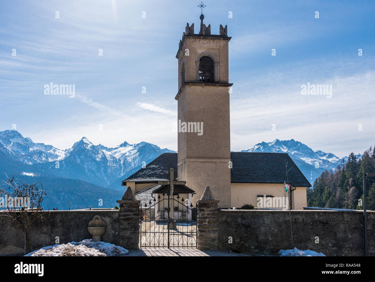 Italian alps as background for mountain church with bell tower and ...