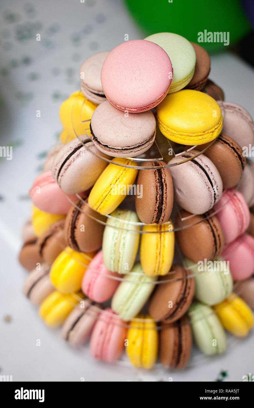 colorful french macarons multilevel cake pyramid on plastic dessert ...