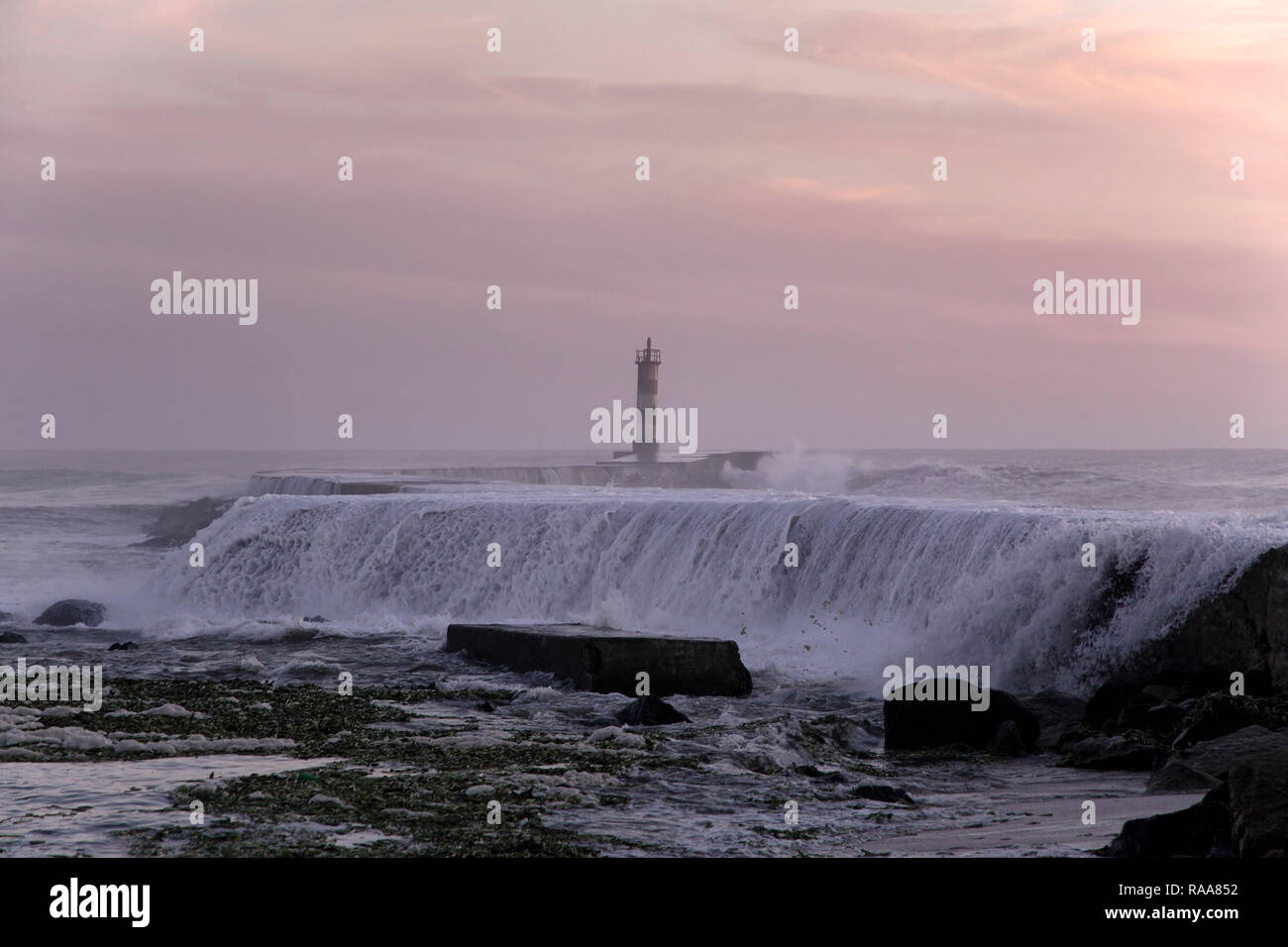 Sea wave water flowing over pier at sunset or dusk. Ave river pier and ...