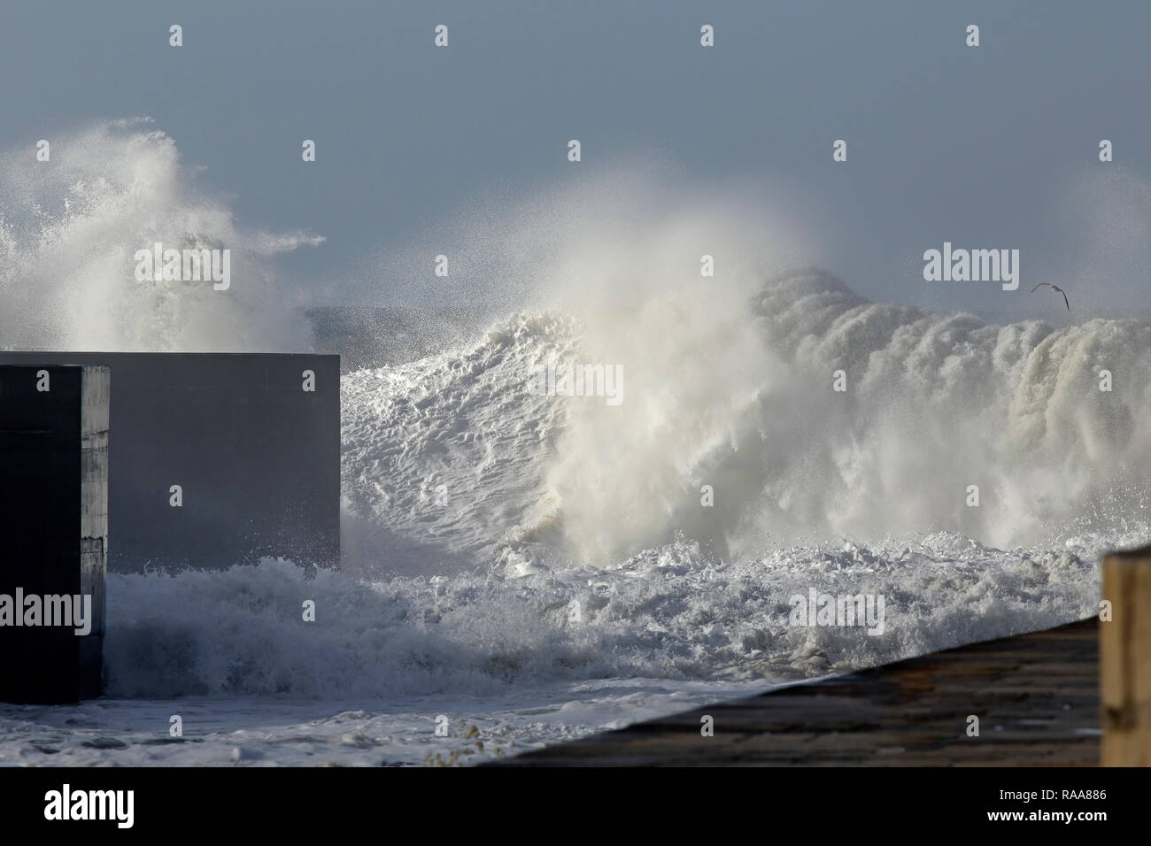 Big strong sea waves against piers in a stormy but clear day Stock ...