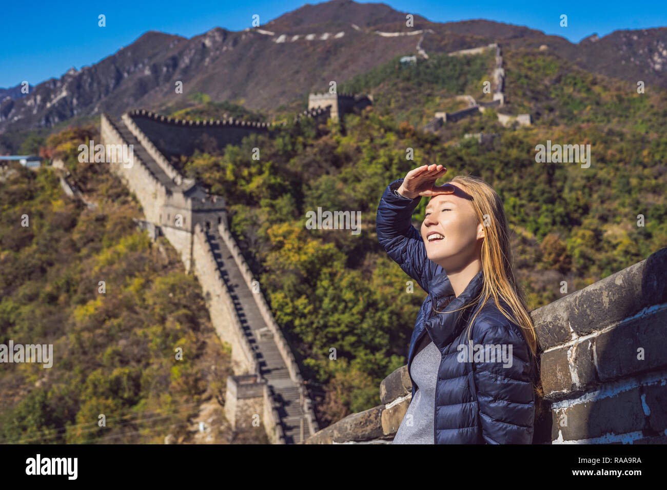 Happy cheerful joyful tourist woman at Great Wall of China having fun ...