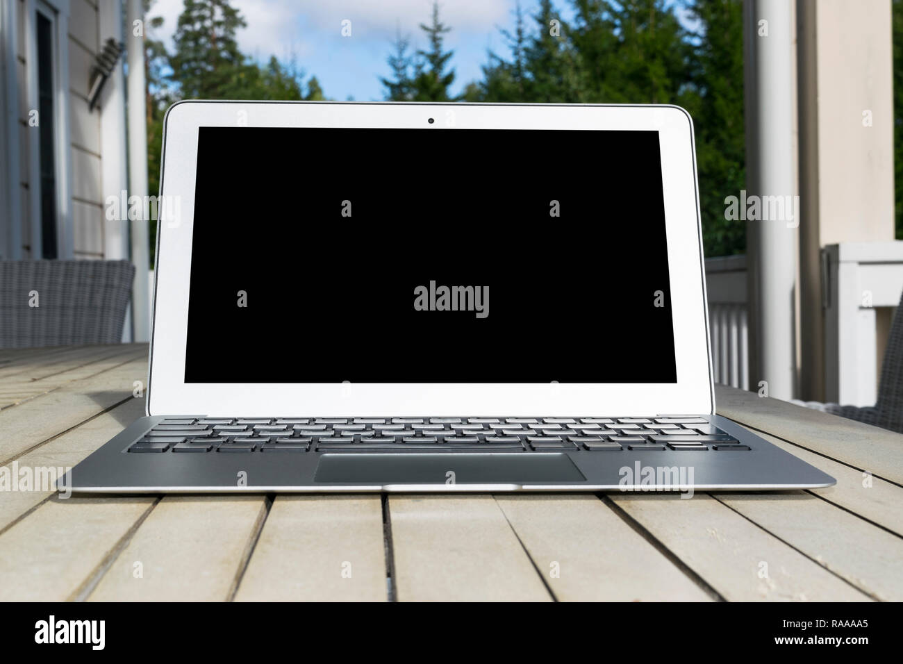 Wooden white office desk table with open blank laptop computer empty ...