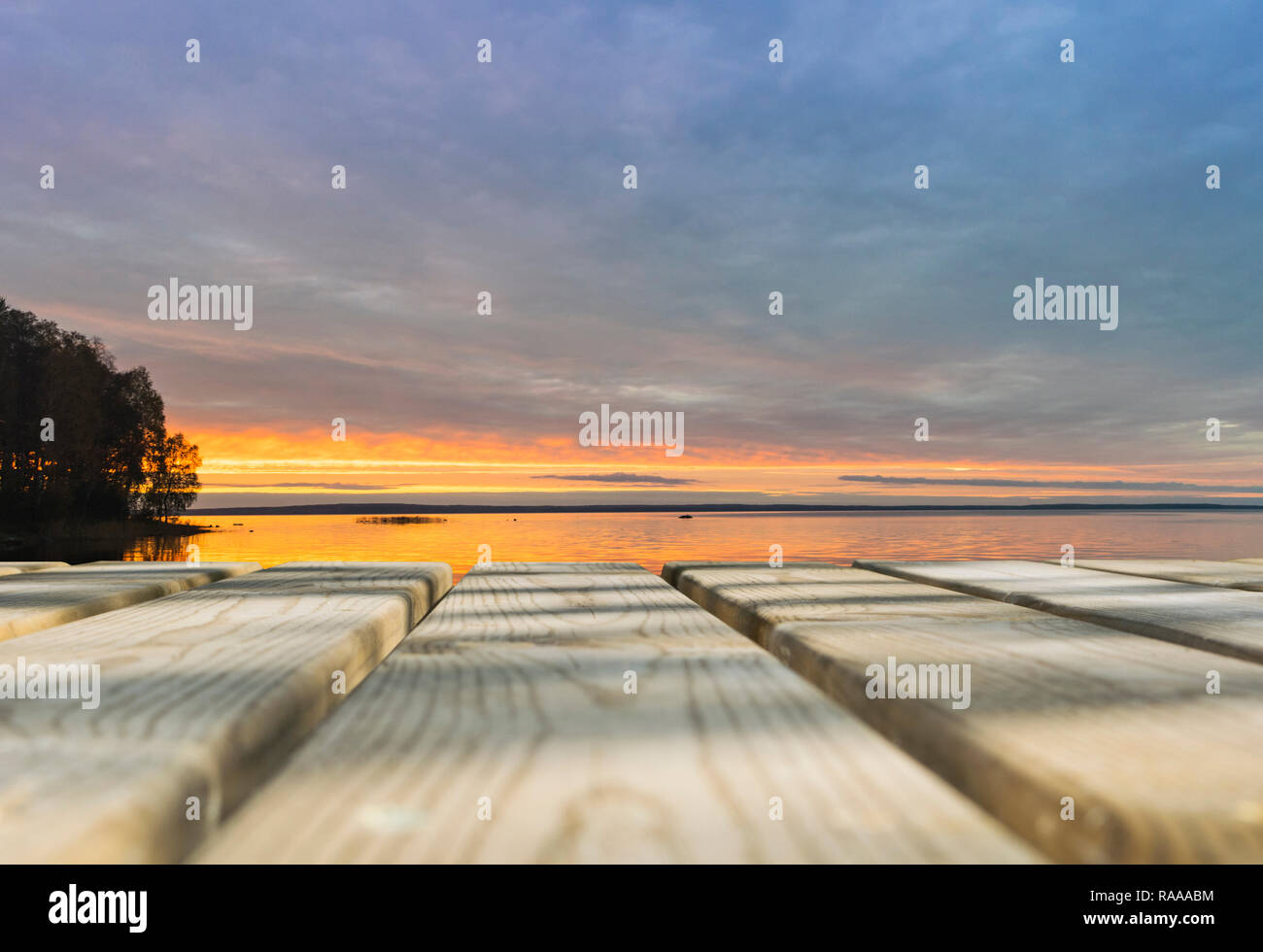 Wooden board empty table in front of sunset sea & sky background ...