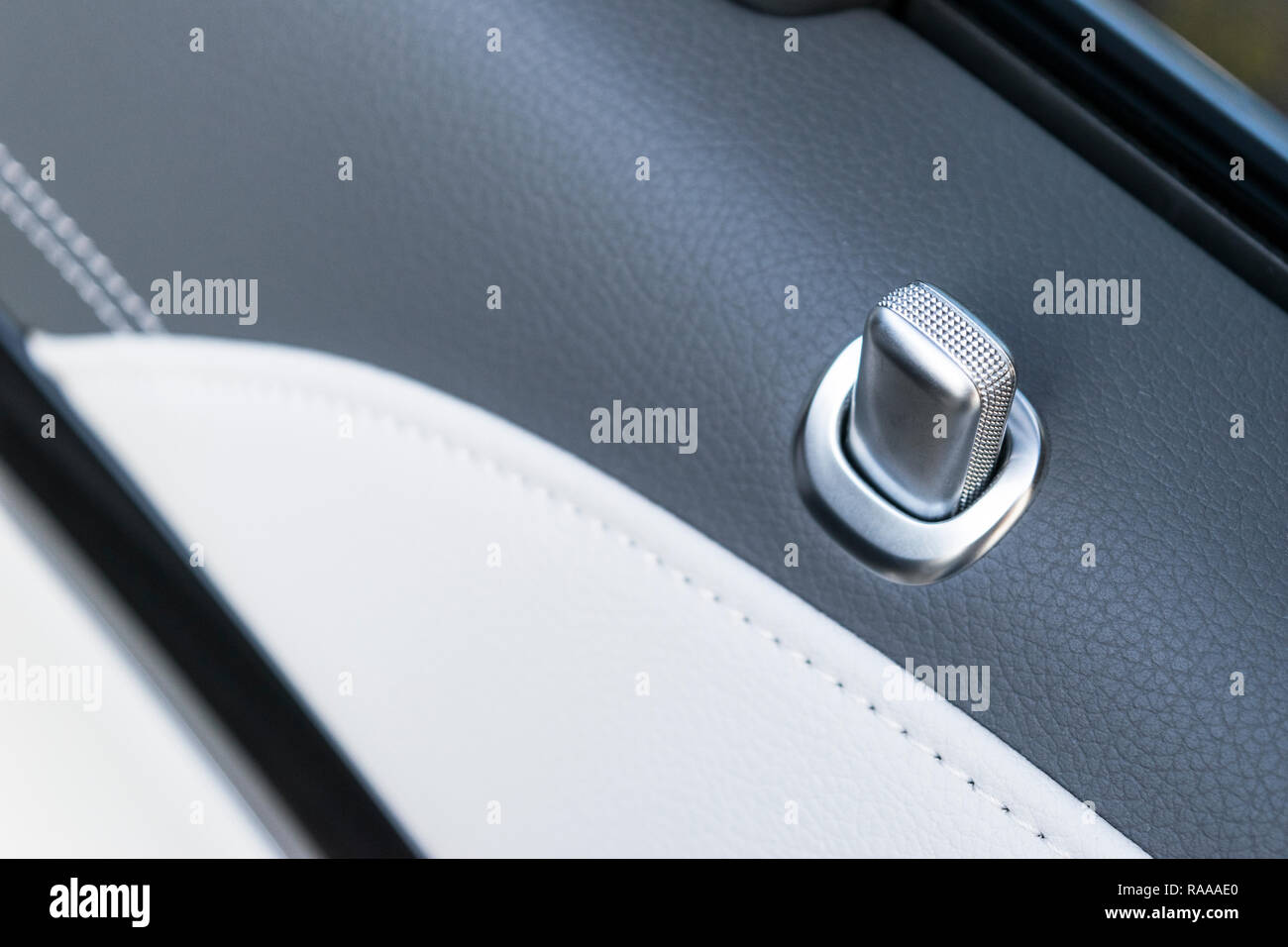 Door handle with lock contol buttons of a luxury passenger car. Black ...