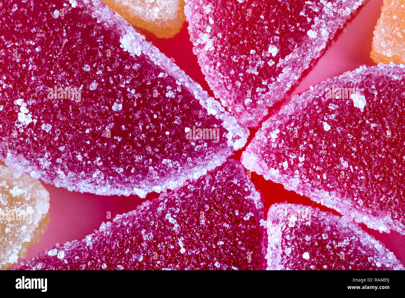 red jelly slices with sugar crystals, background image Stock Photo - Alamy