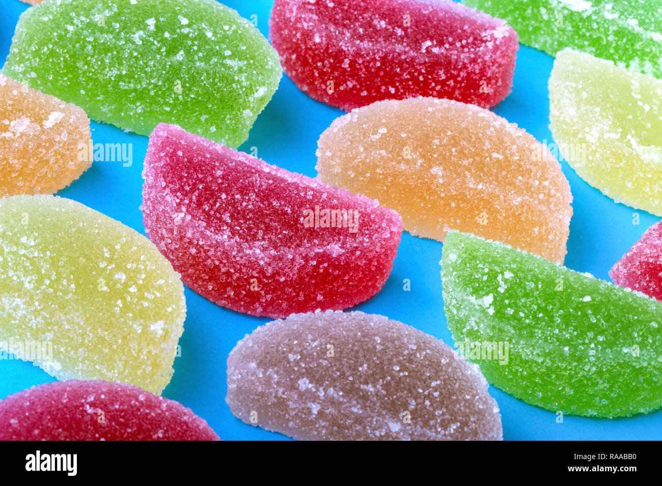 colored fruit jelly with sugar crystals on a blue background Stock ...