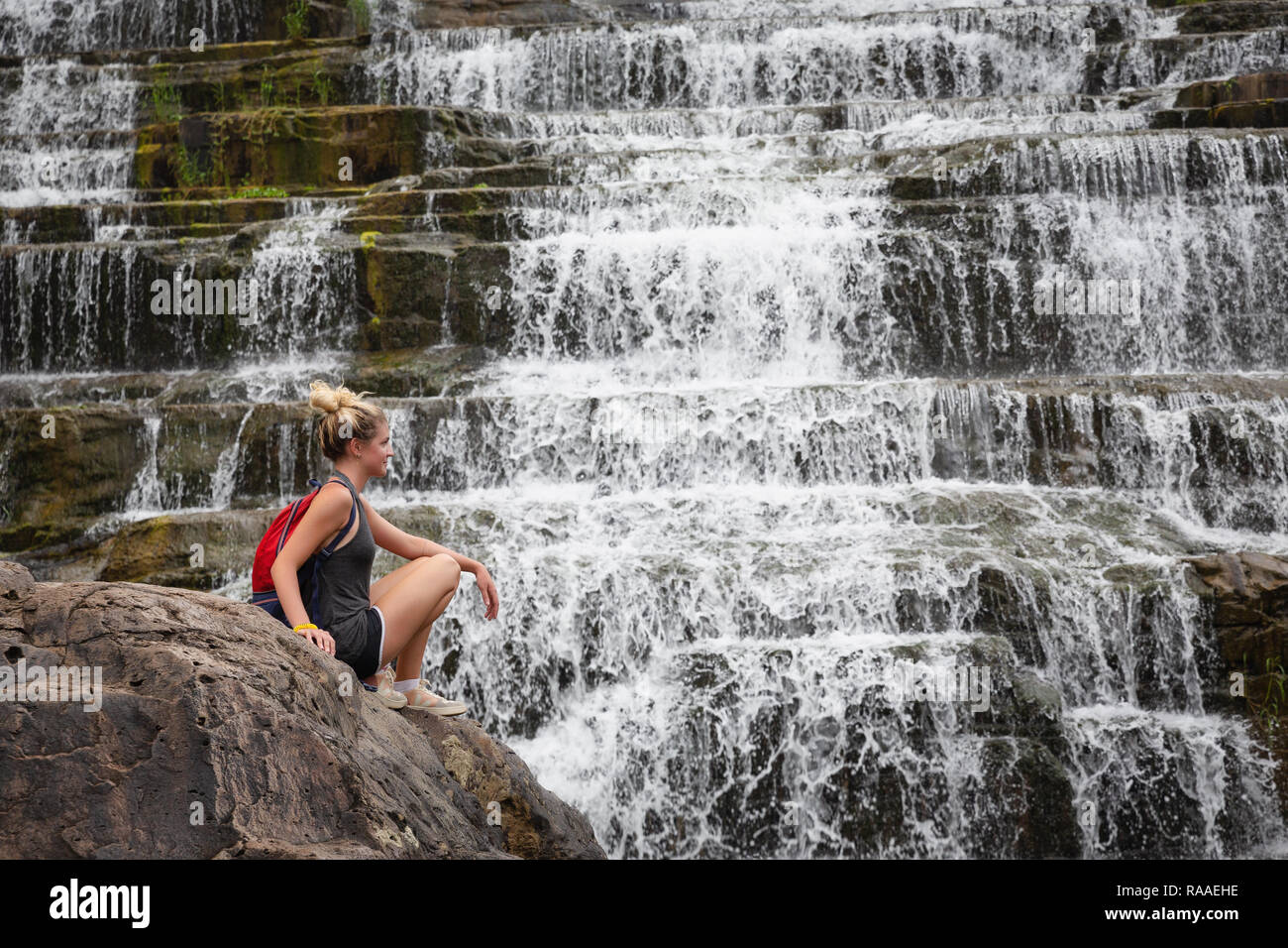 Young girl sitting waterfall High Resolution Stock Photography and ...