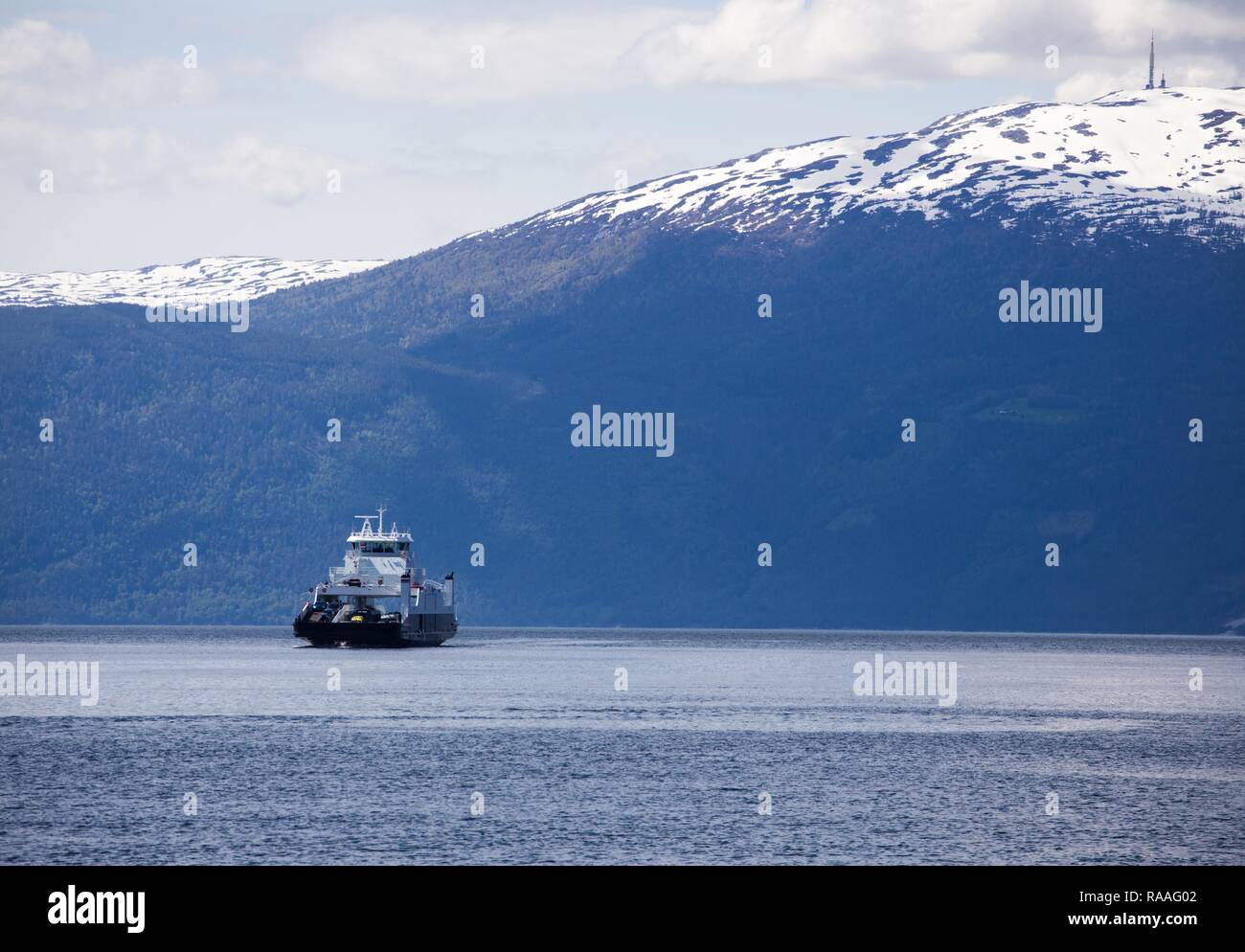 ferry crossing a norwegian fjord with mountains at the background Stock ...