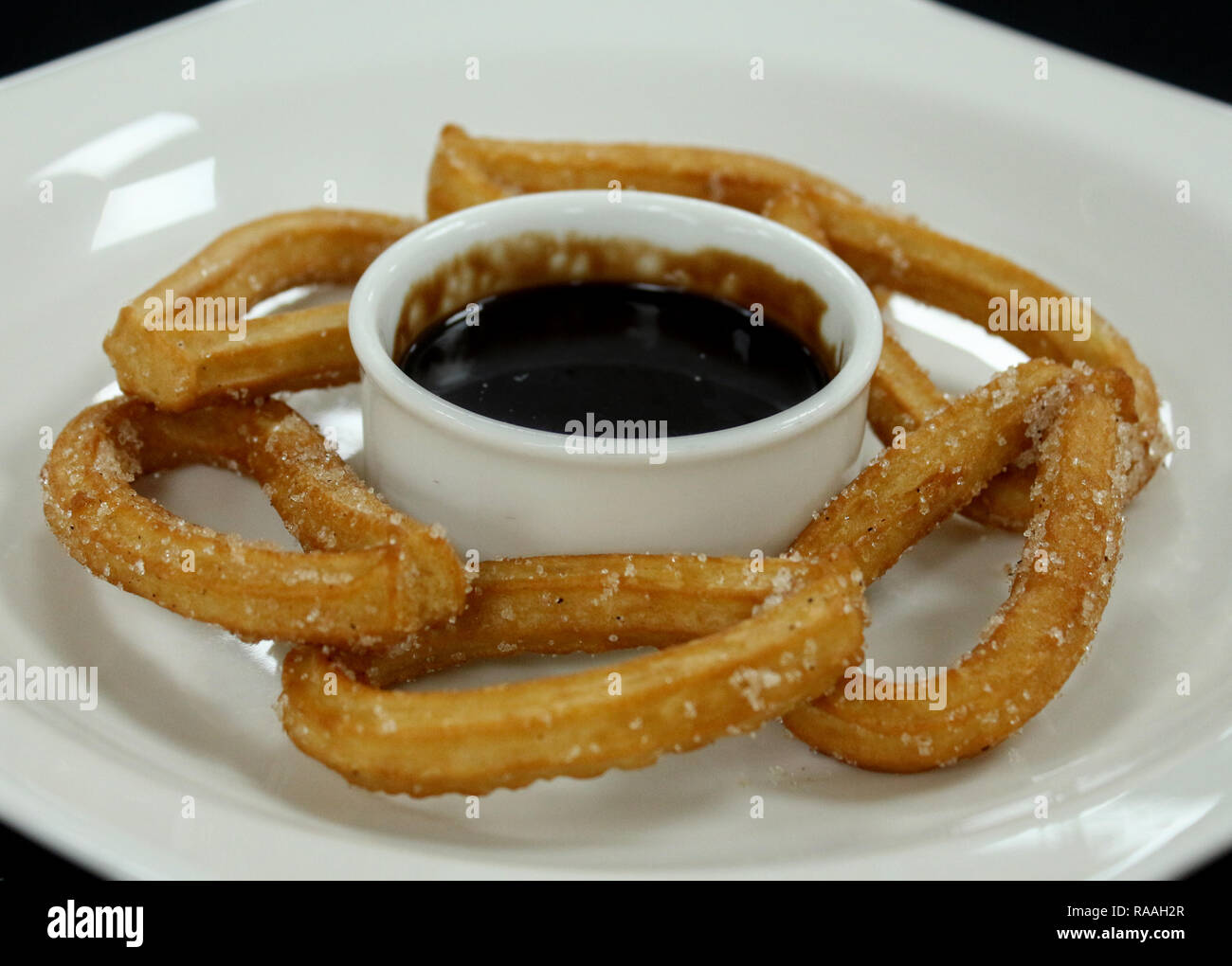 cinnamon churros with chocolate dipping sauce Stock Photo - Alamy