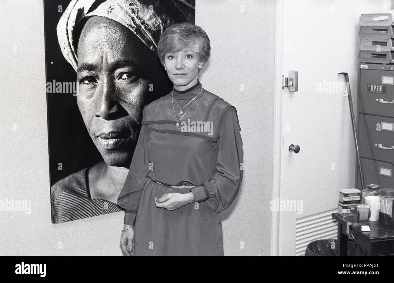LADY STANDING IN FRONT OF A PICTURE IN THE OFFICE Stock Photo - Alamy