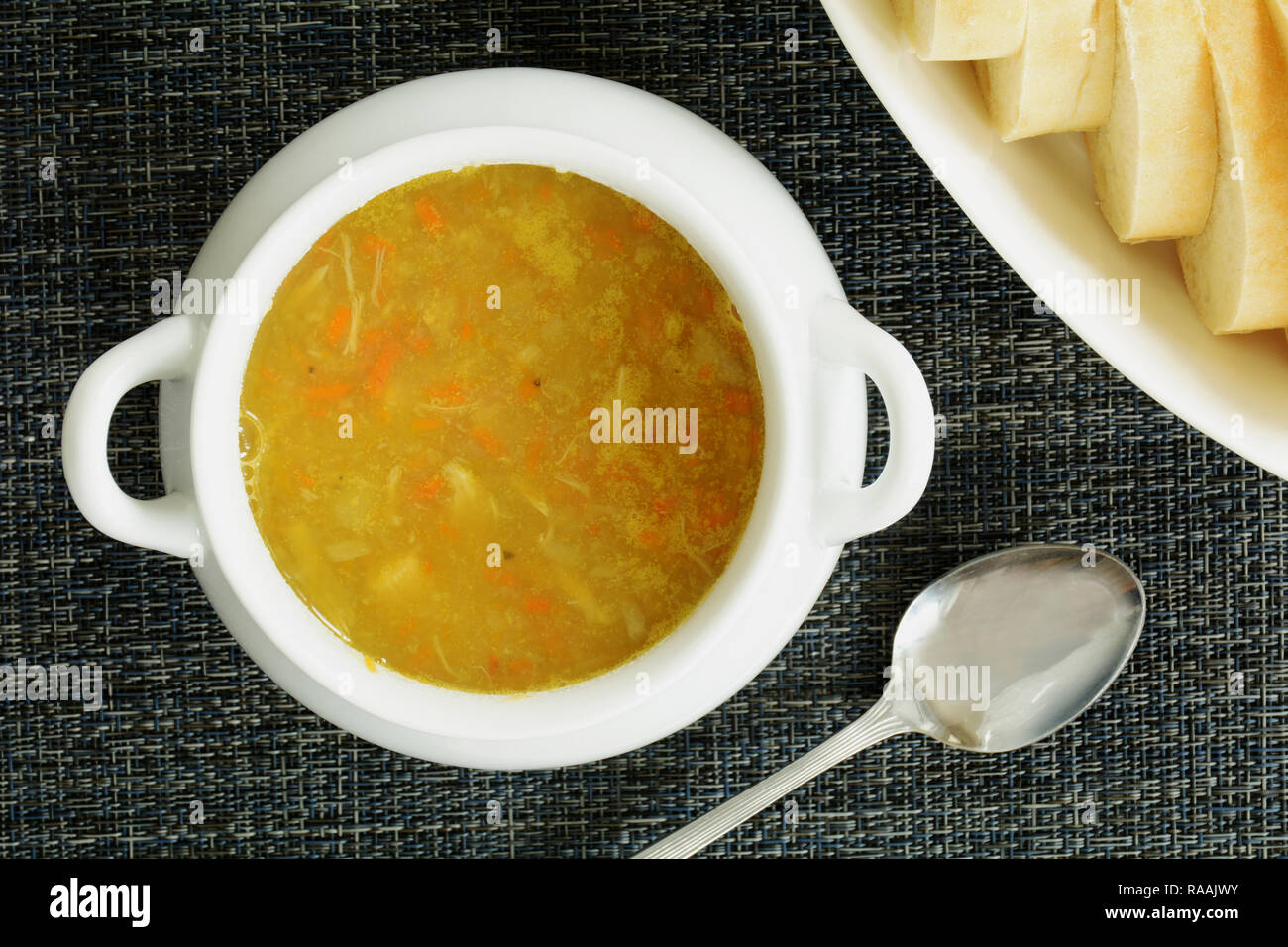 Home made chicken vegetable soup with bread shot from overhead in ...